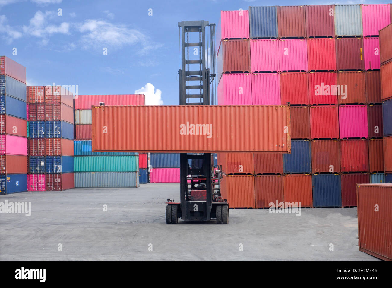 Container handlers work in cargo ports, cargo stations Stock Photo - Alamy