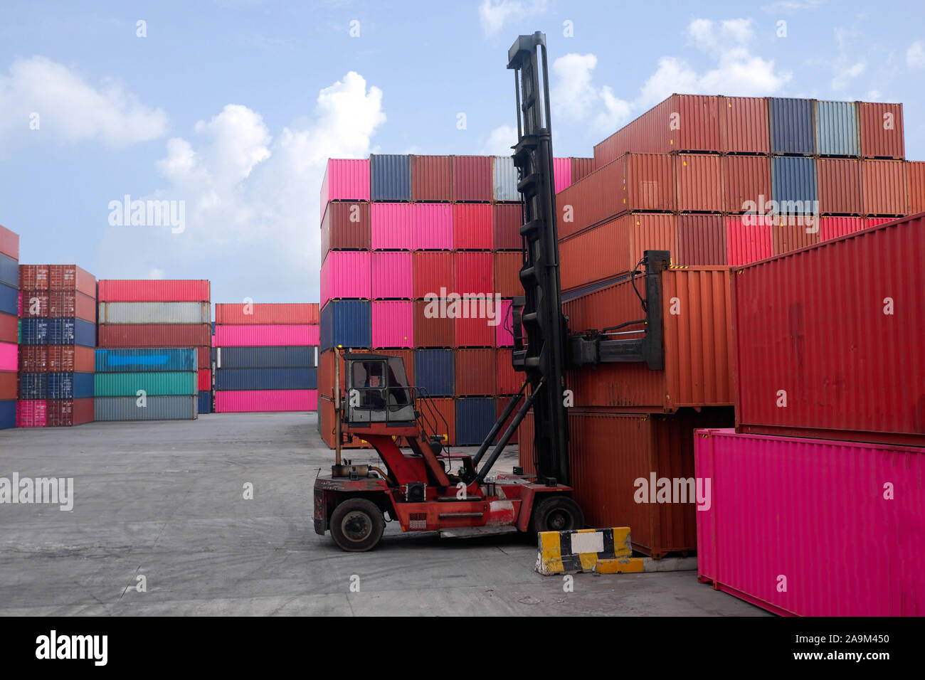 Container handlers work in cargo ports, cargo stations Stock Photo - Alamy
