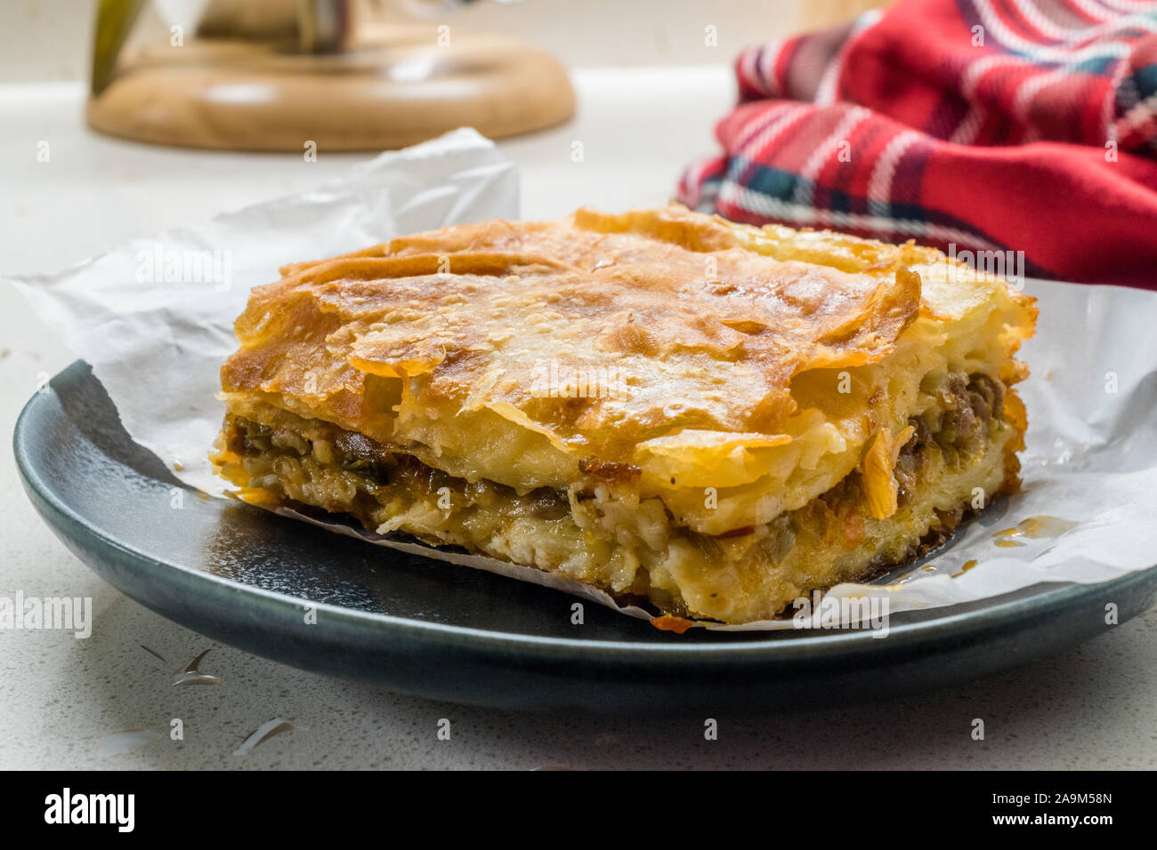 Turkish Borek with Minced Meat and Leek on Wooden Board with Paper ...