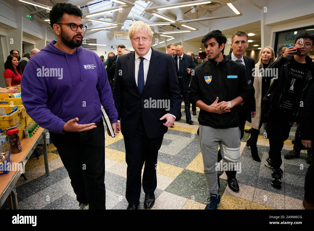 Prime Minister Boris Johnson (centre) speaks to staff and students ...