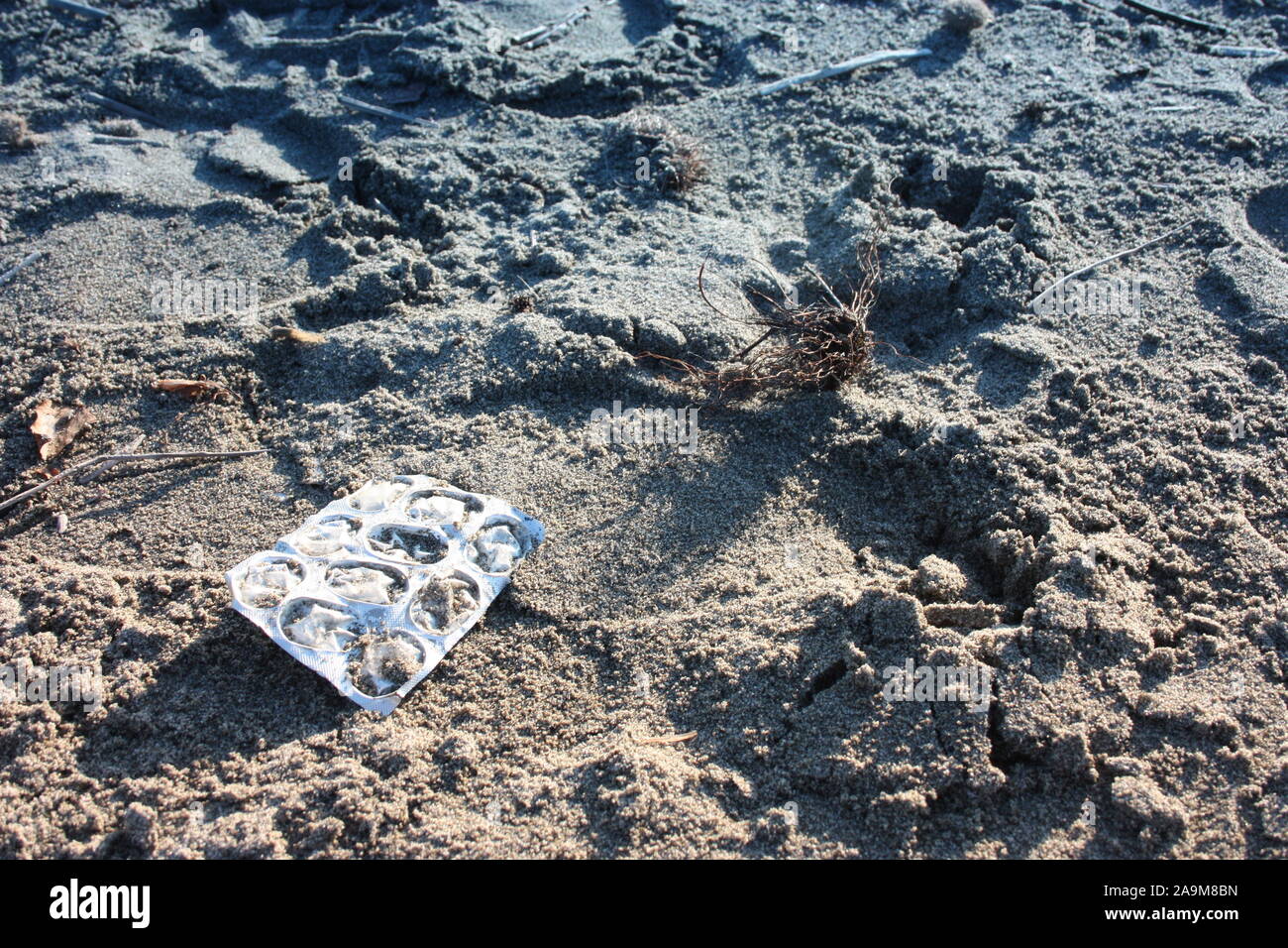 a pack of pills. blister of medicines left on the sandy beach ...