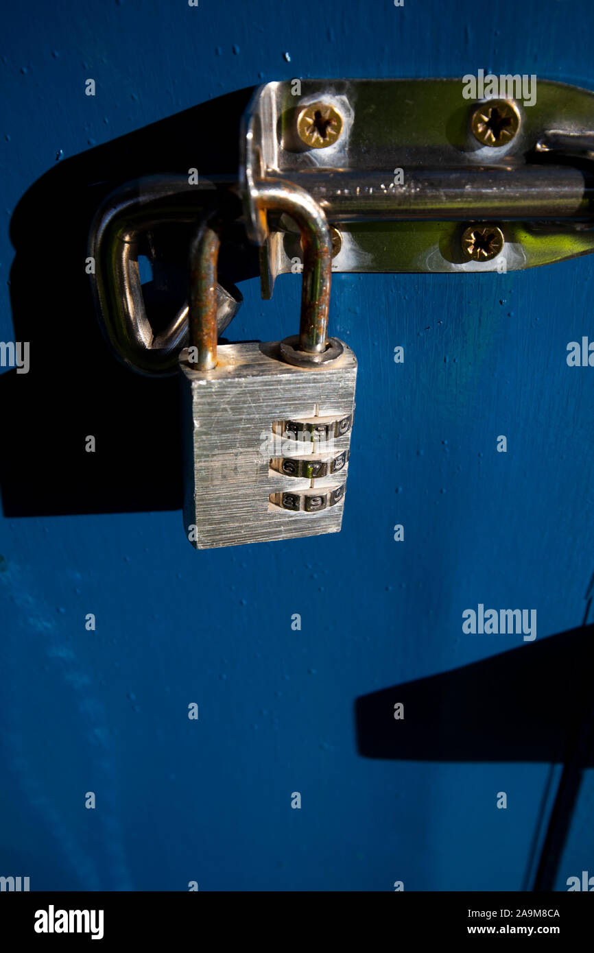 padlock and bolt fixed to timber door providing security to building ...