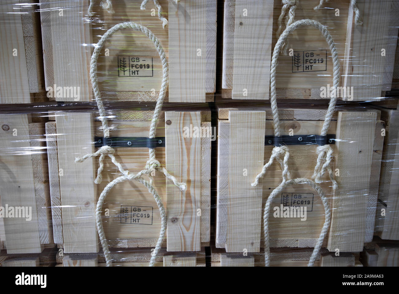 Stacked timber packing boxes with rope carrying handles wrapped in ...