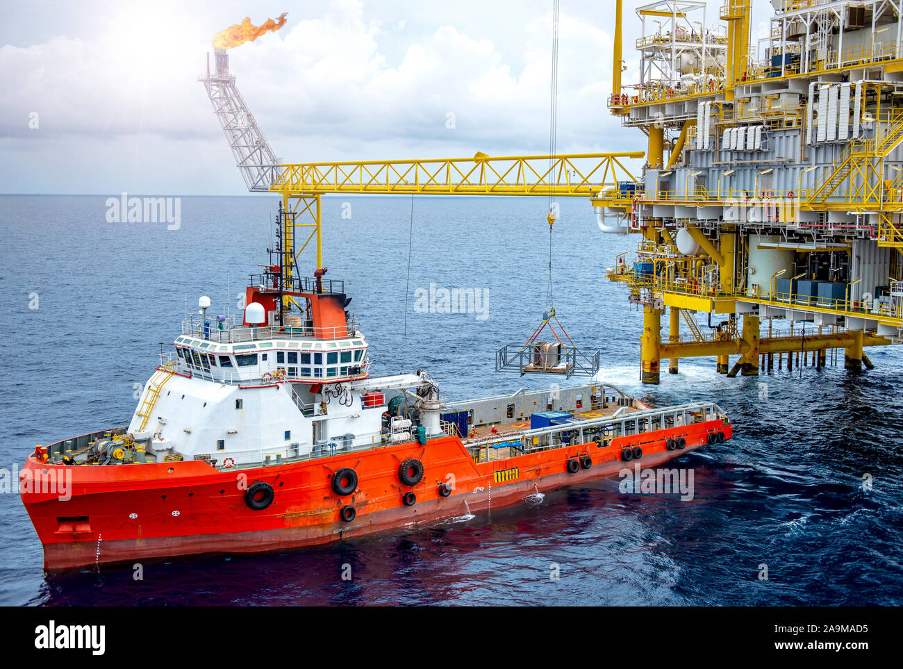 Shipping box is loaded from an offshore rig to the supply vessel Stock ...