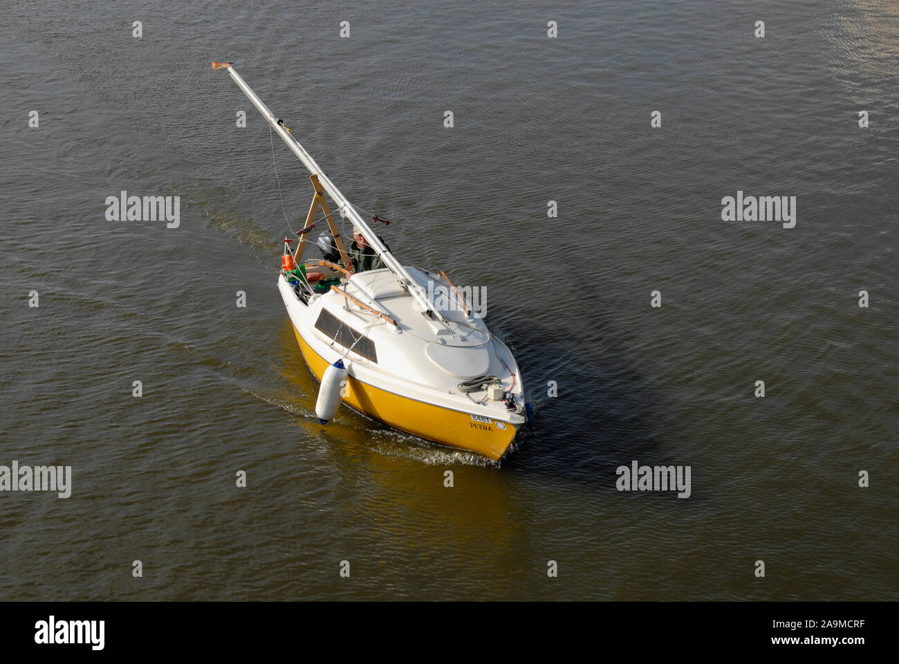 One man in small yacht with mast down to eneble it to pass under Acle ...
