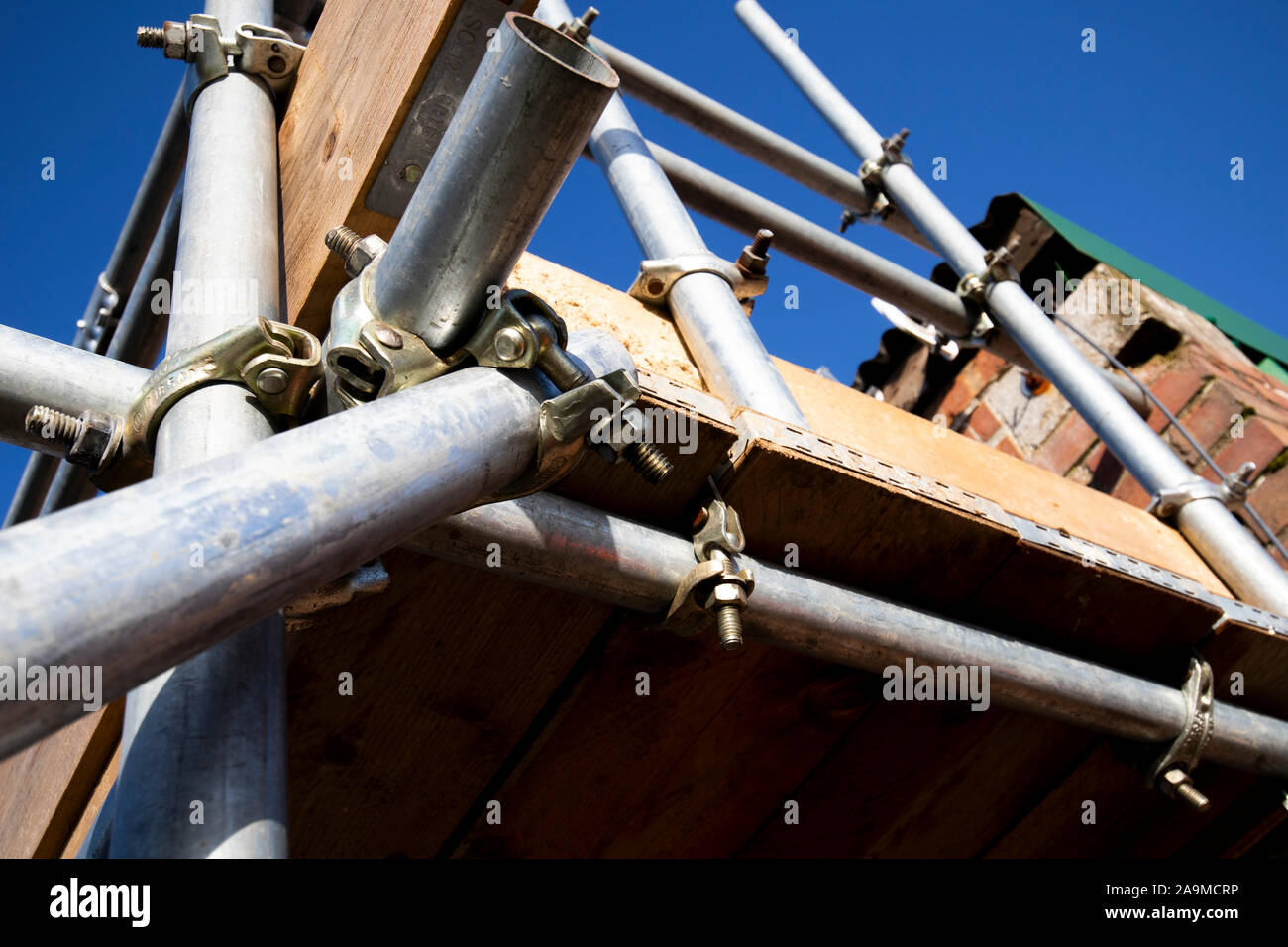 Scaffolding poles and boards erected on old building for renovation ...