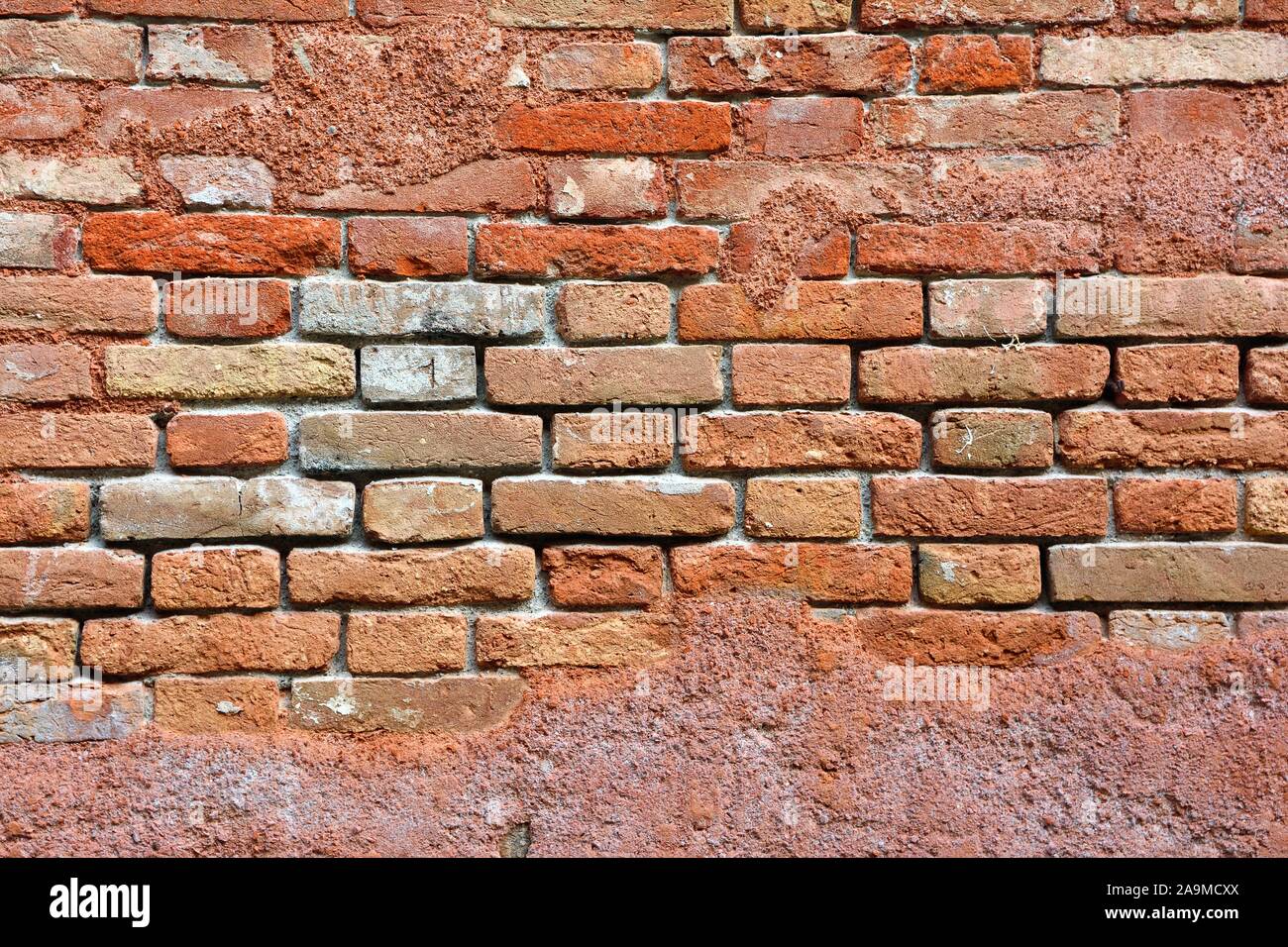 Red brick wall with saltpeter and moisture in Venice Stock Photo - Alamy