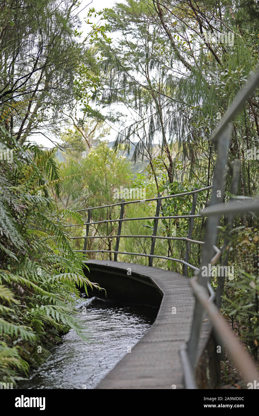 Footpath bridge along a stream Stock Photo - Alamy