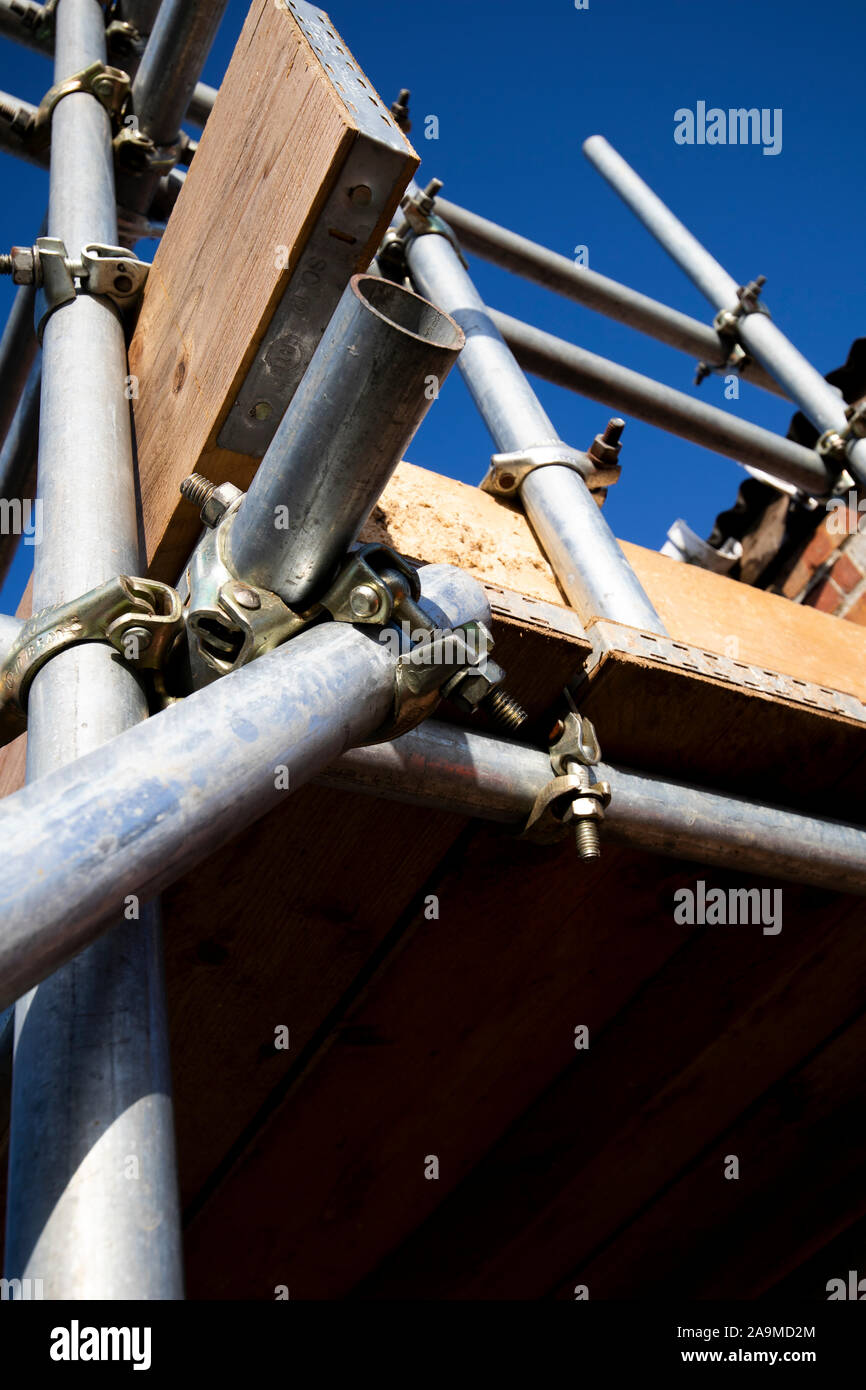 Scaffolding poles and boards erected on old building for renovation ...