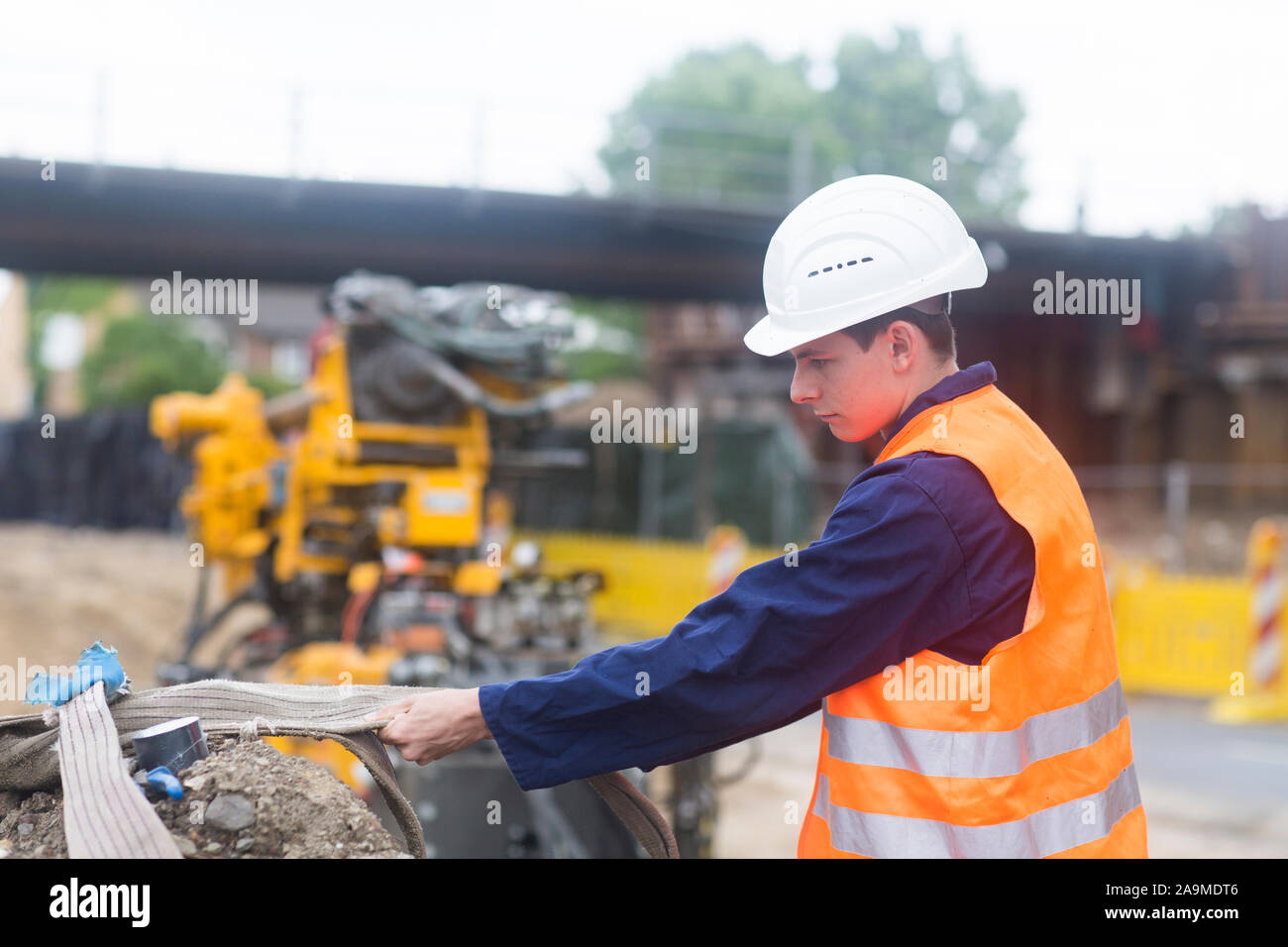 worker young male checking tool Stock Photo - Alamy