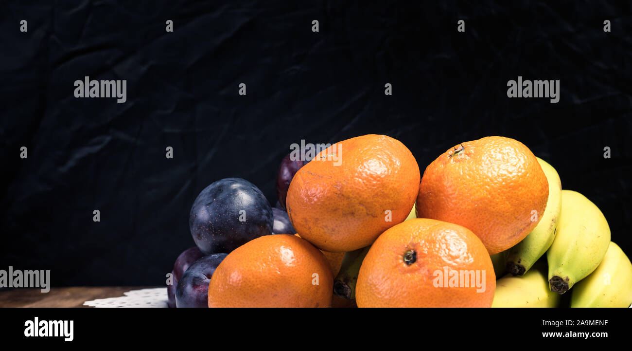 Fresh fruit selection against dark background Stock Photo - Alamy