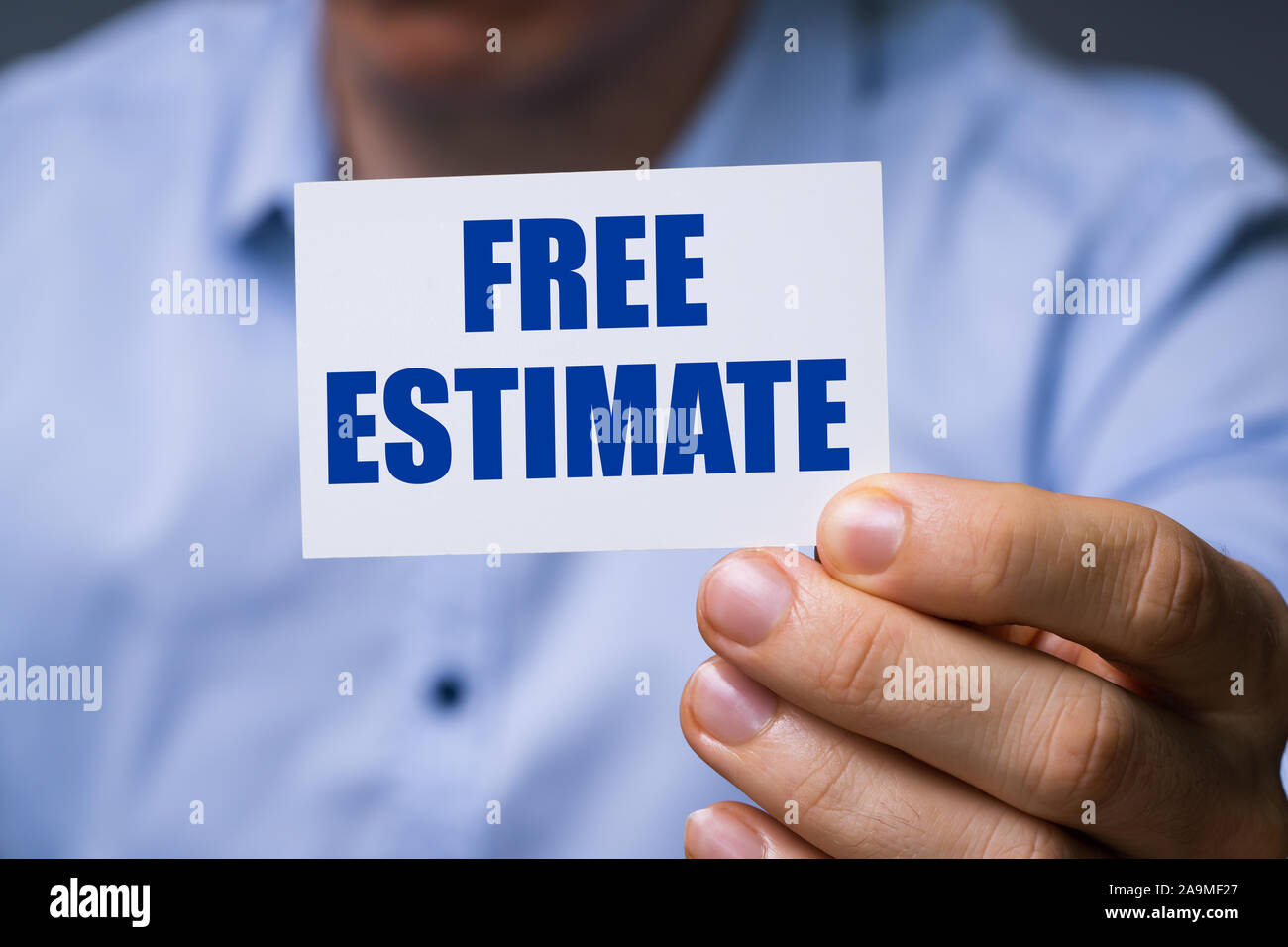 Man Showing Card With Free Estimate Text Stock Photo - Alamy