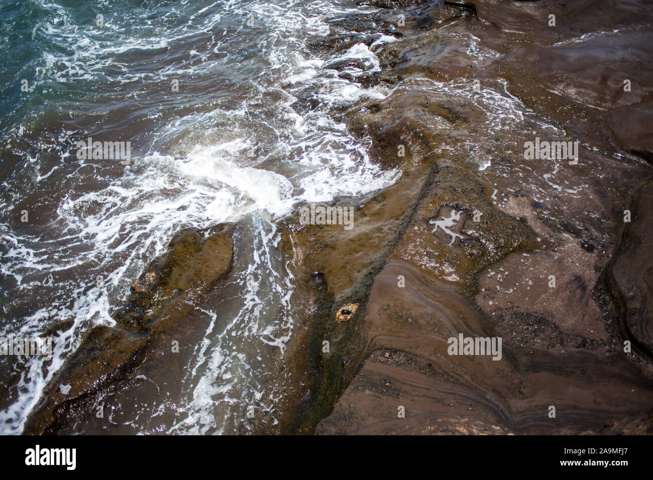 Water edge. Shiny texture of azure surface of mountain lake. Stony ...