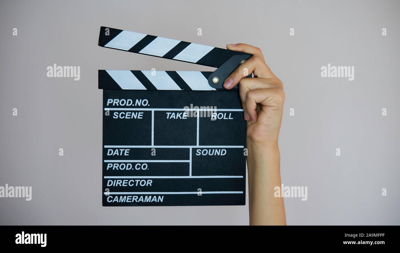 Female hand holding wooden movie clapper Stock Photo - Alamy