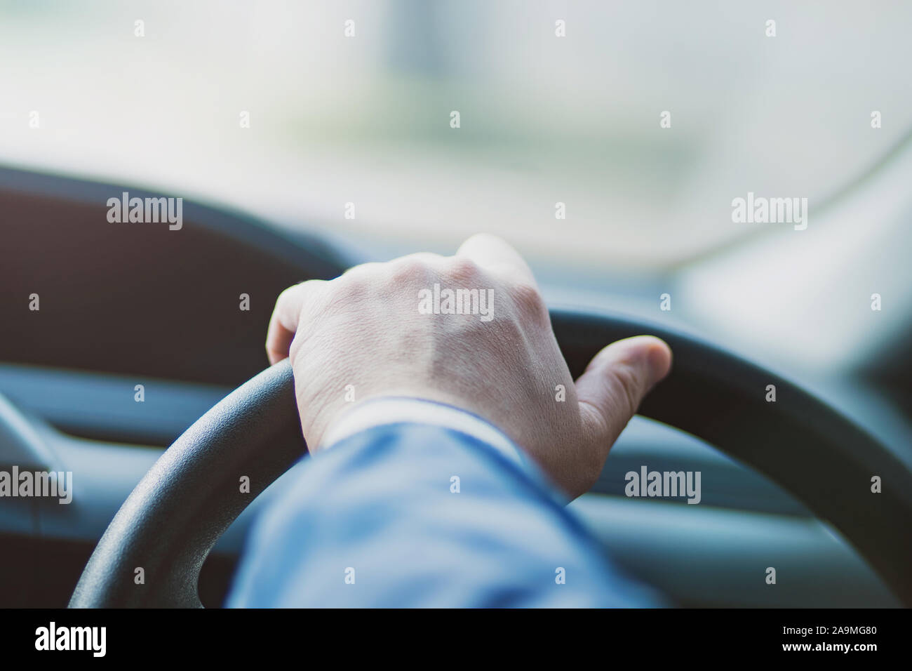 Men's hands on the wheel of the car, transportation Stock Photo - Alamy