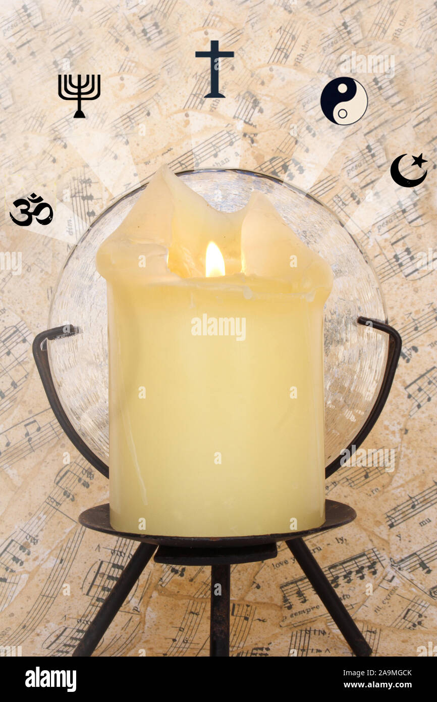 Lighted candle sorrounded for religious symbols Stock Photo - Alamy