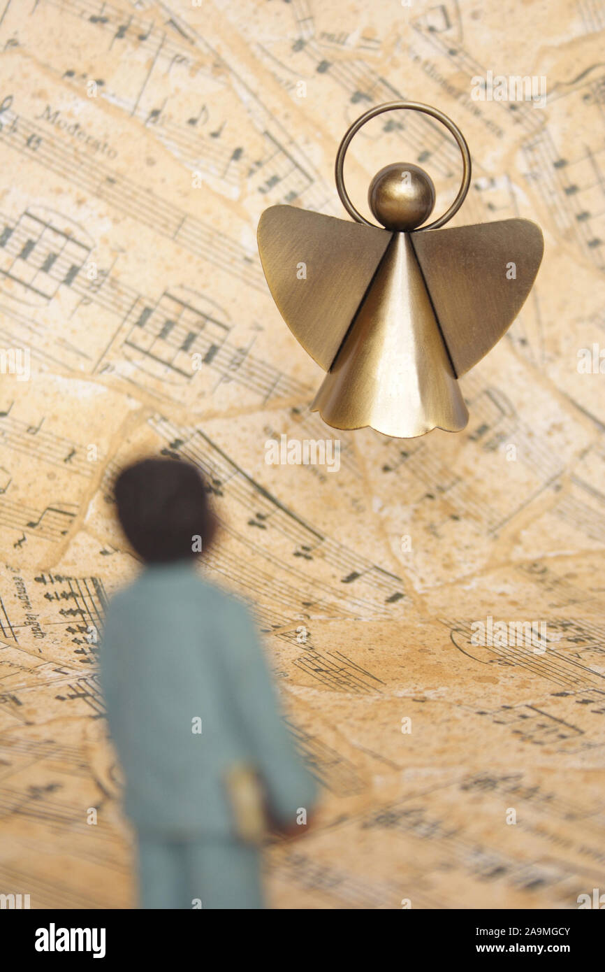 Boy and angel with a music sheet as background Stock Photo - Alamy