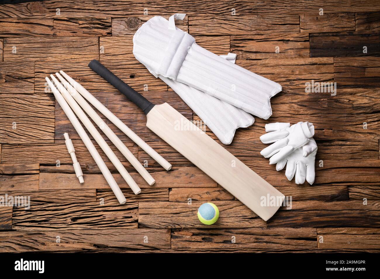 Elevated View Of Cricket Accessories And Tools On Brown Textured ...