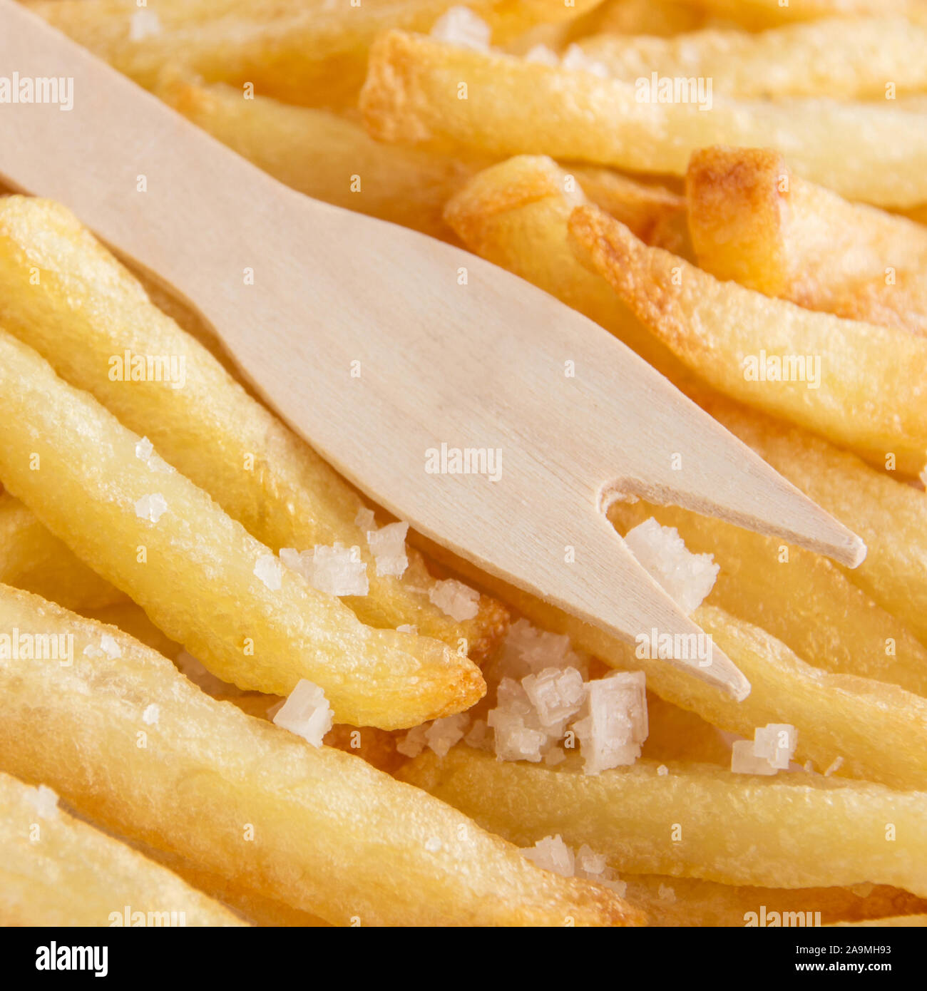 French fries and salt with fork in close-up background Stock Photo - Alamy