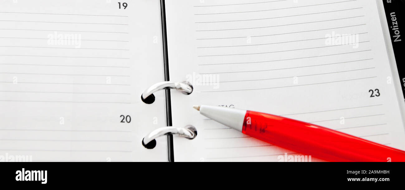 Calendar with red ballpoint pen close-up as background Stock Photo - Alamy