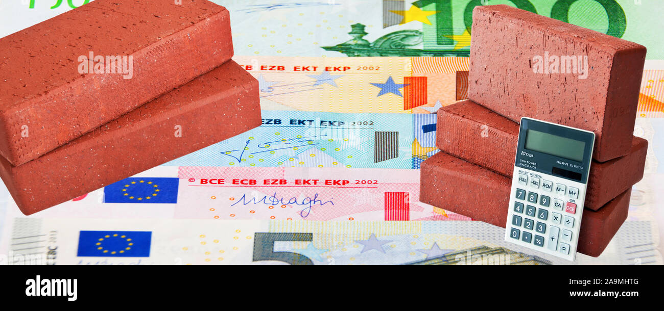 Calculator and brick stones Stock Photo - Alamy