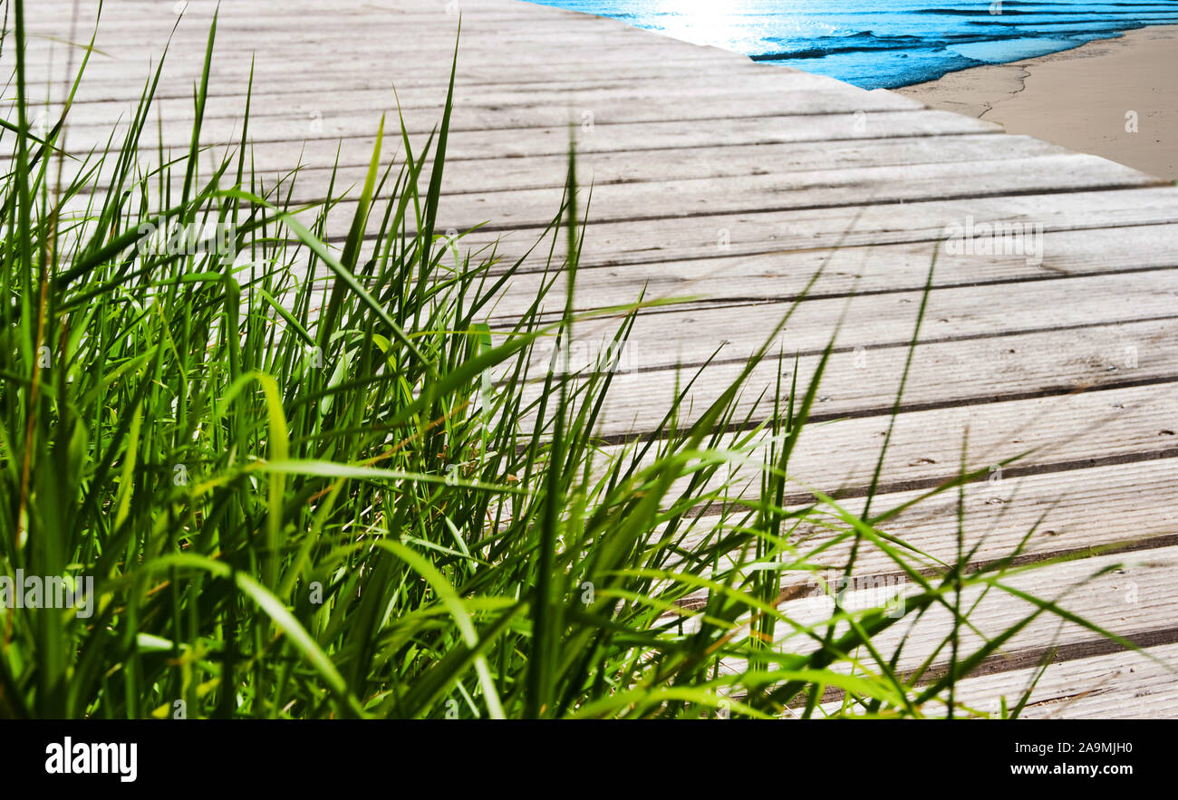 Wellness beach with wooden bridge background Stock Photo - Alamy