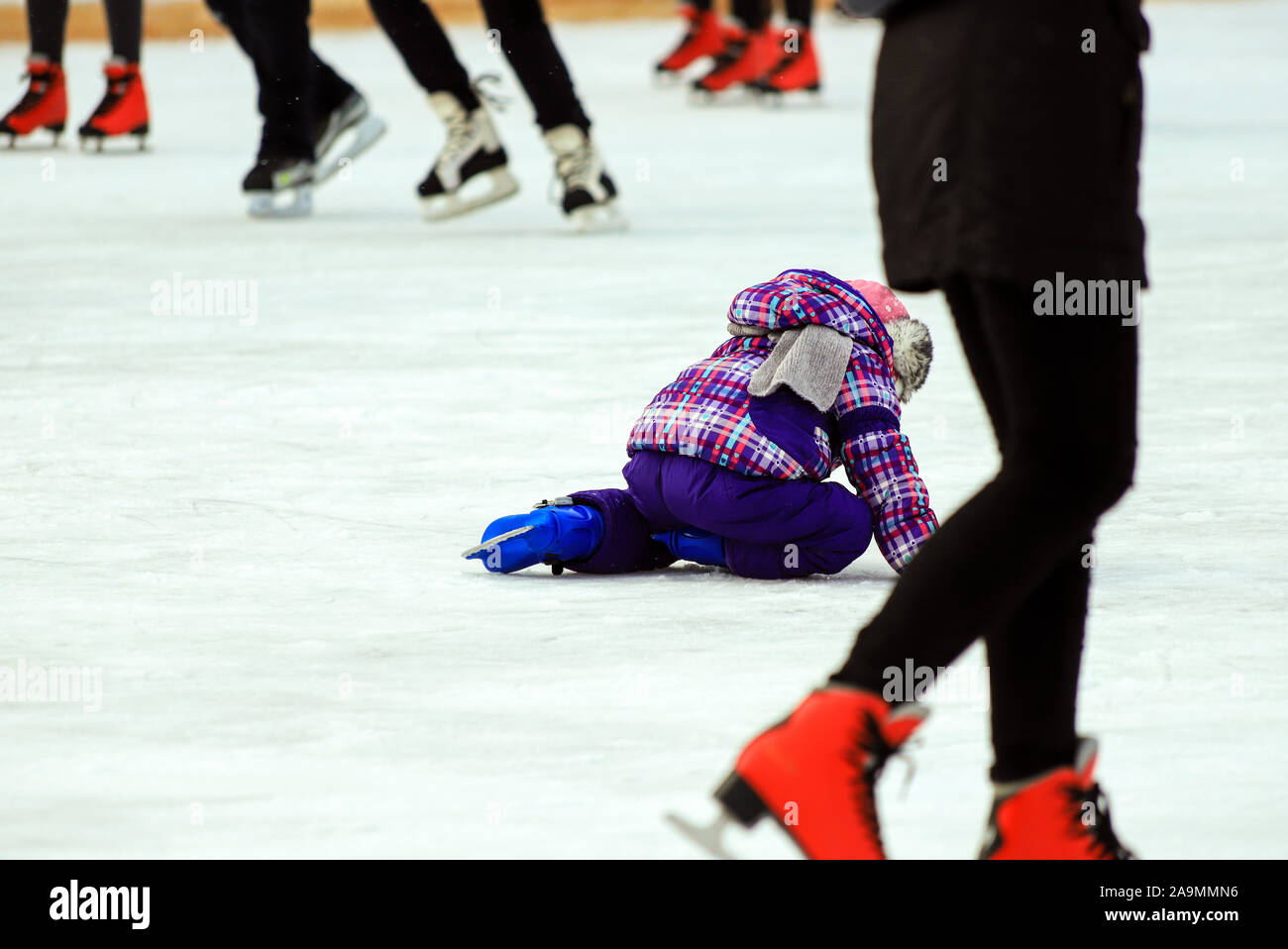 A little boy skates and falls on the ice in children skate rink Active ...