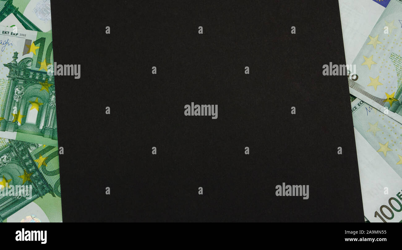 Many Banknotes of 100 Euro with black copy space, the European currency ...