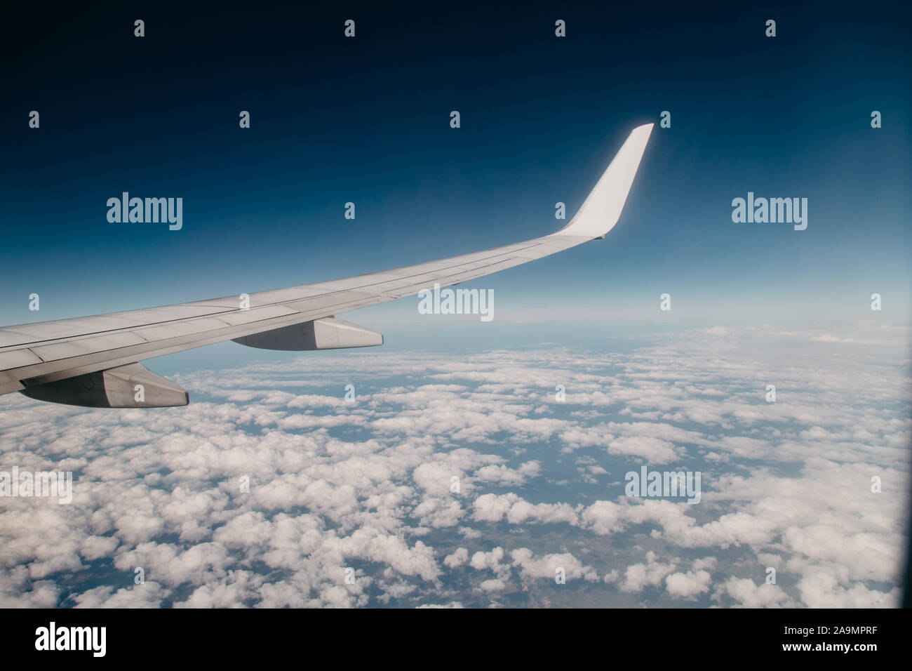 Airplane wing through the window Stock Photo - Alamy