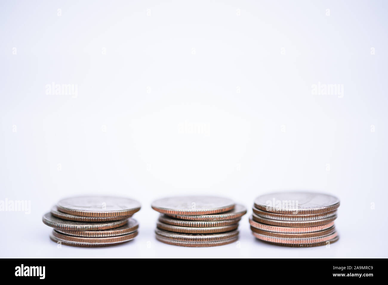 coins stacked on white background quarters and change Stock Photo - Alamy