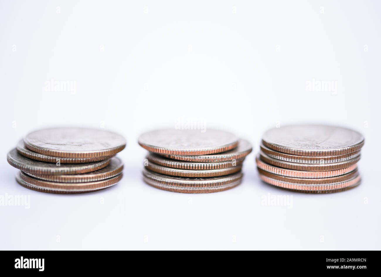 coins stacked on white background quarters and change Stock Photo - Alamy