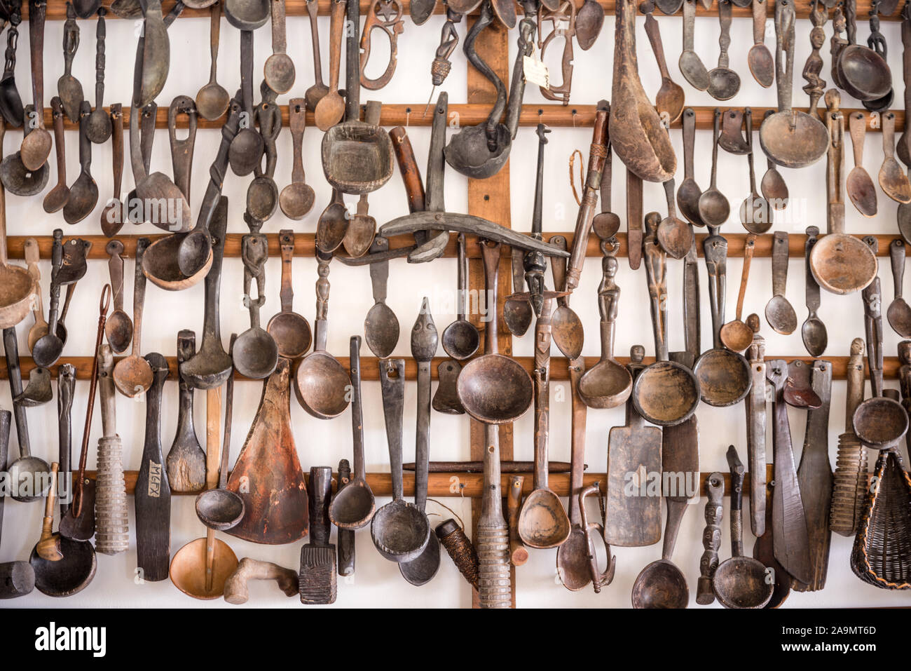 Wooden kitchen utensils hanged as decorative display on wall Stock ...