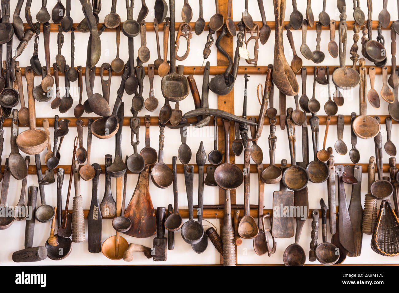Wooden kitchen utensils hanged as decorative display on wall Stock ...