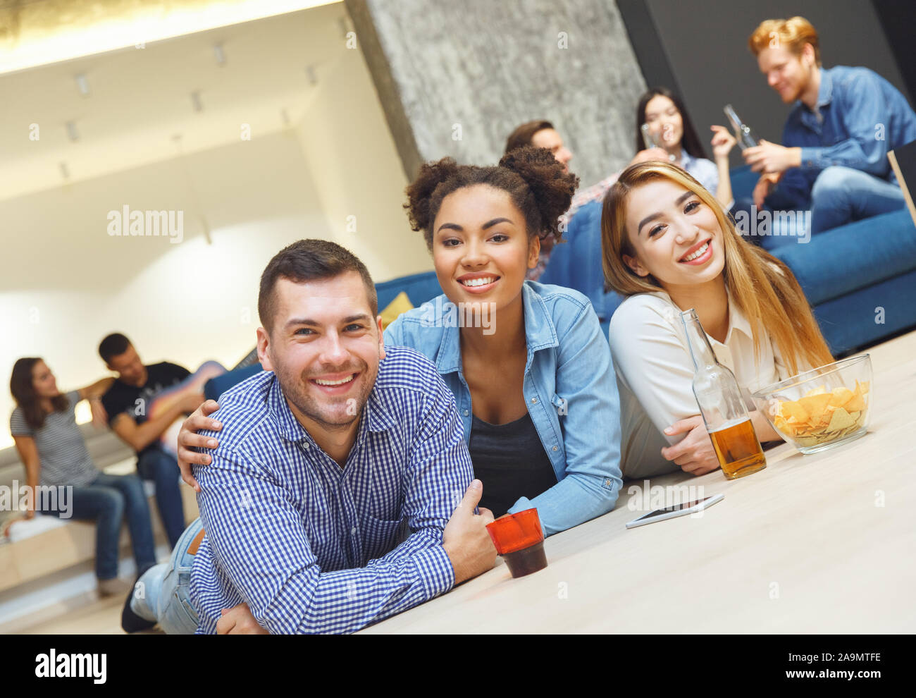 Group of friends having party indoors fun together looking camera Stock ...