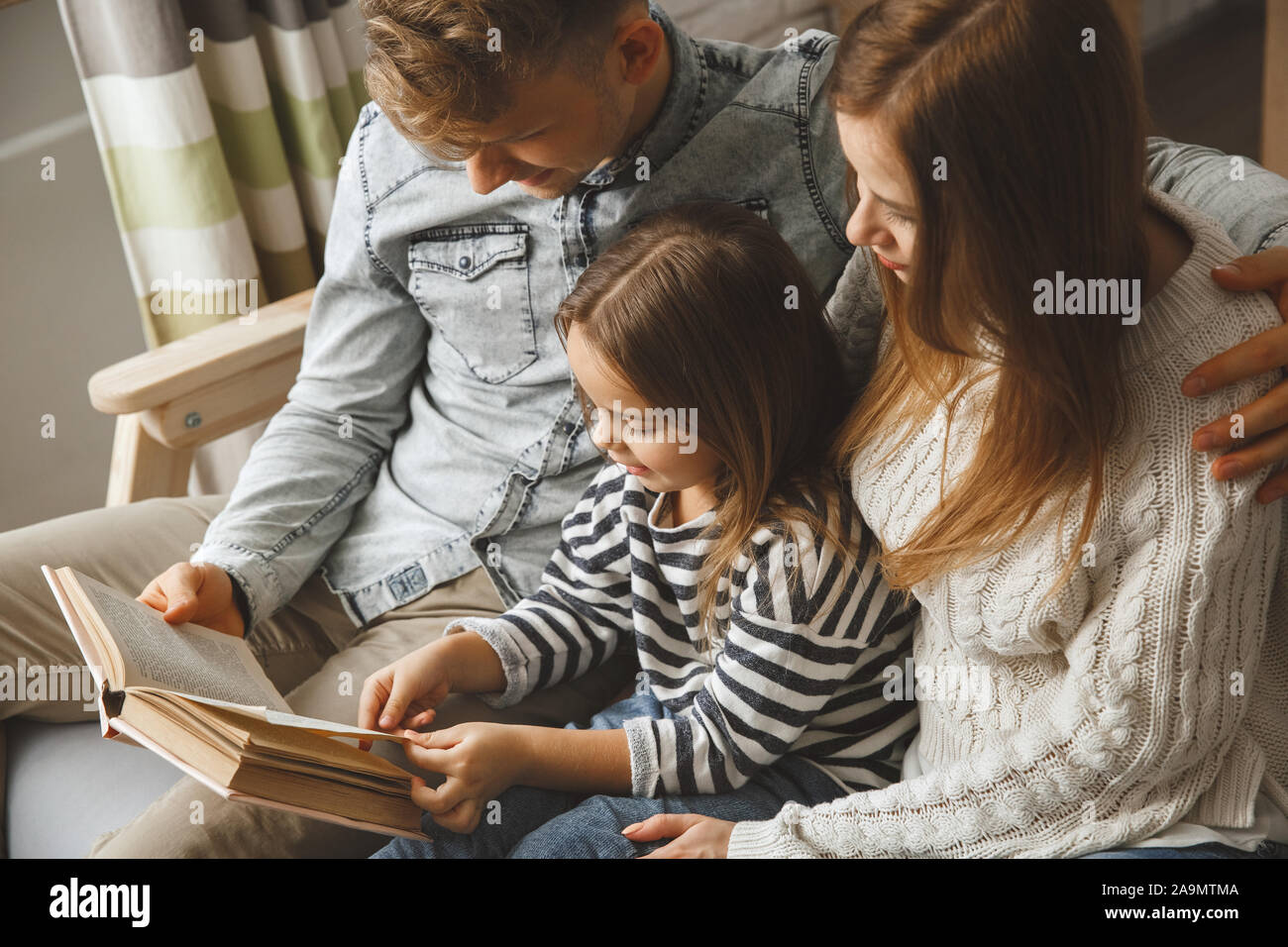 Family at home together leisure love concept reading fairy tale Stock ...
