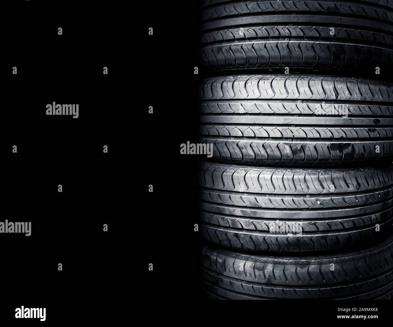 Studio shot of a set of summer car tires isolated on black background ...