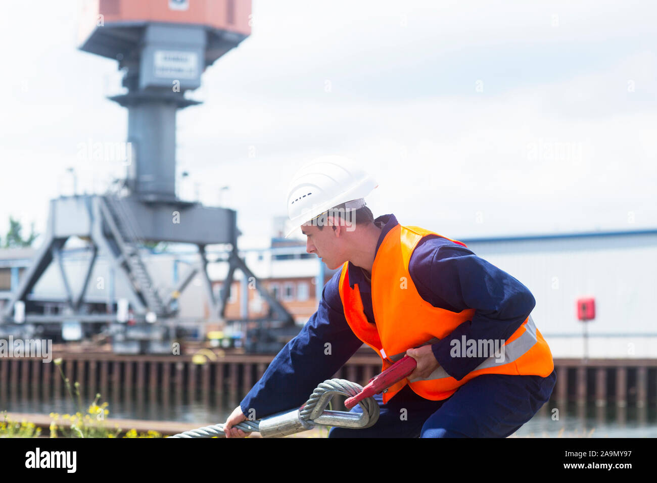 worker young male pulling wire Stock Photo - Alamy