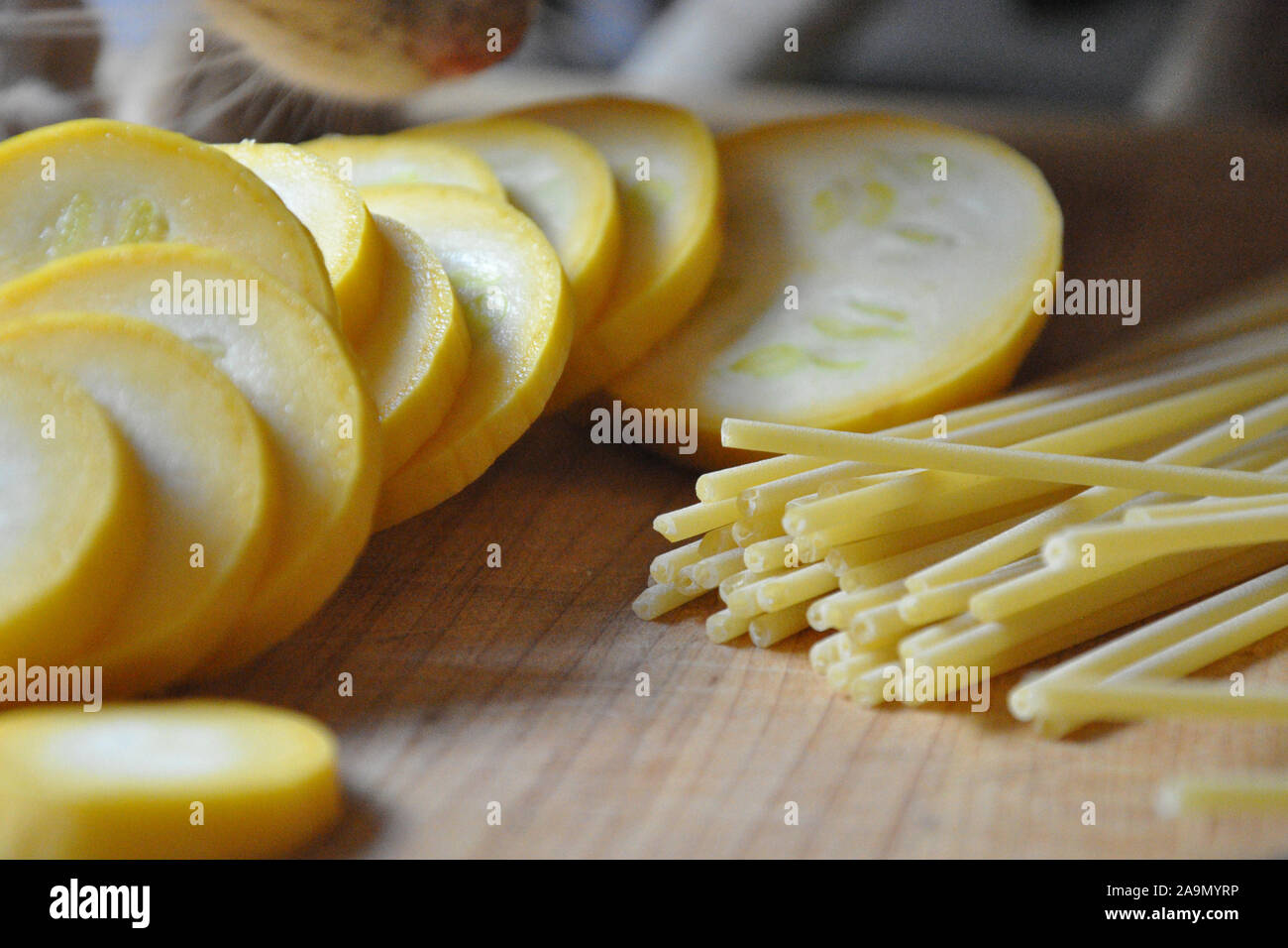 Nose of Cat sniffing sliced yellow squash and pasta noodles Stock Photo ...