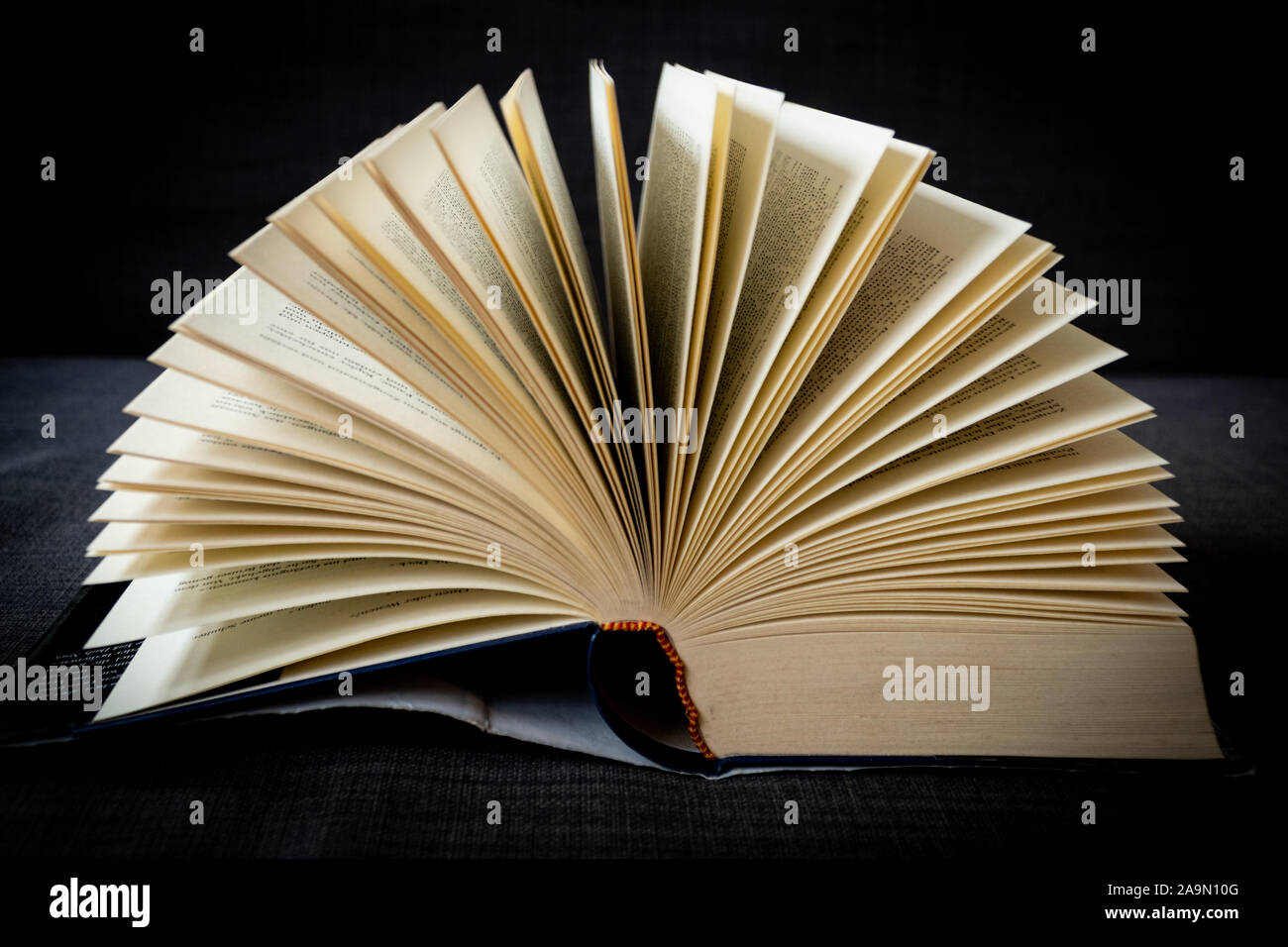 Side view of an open old book with many pages Stock Photo - Alamy