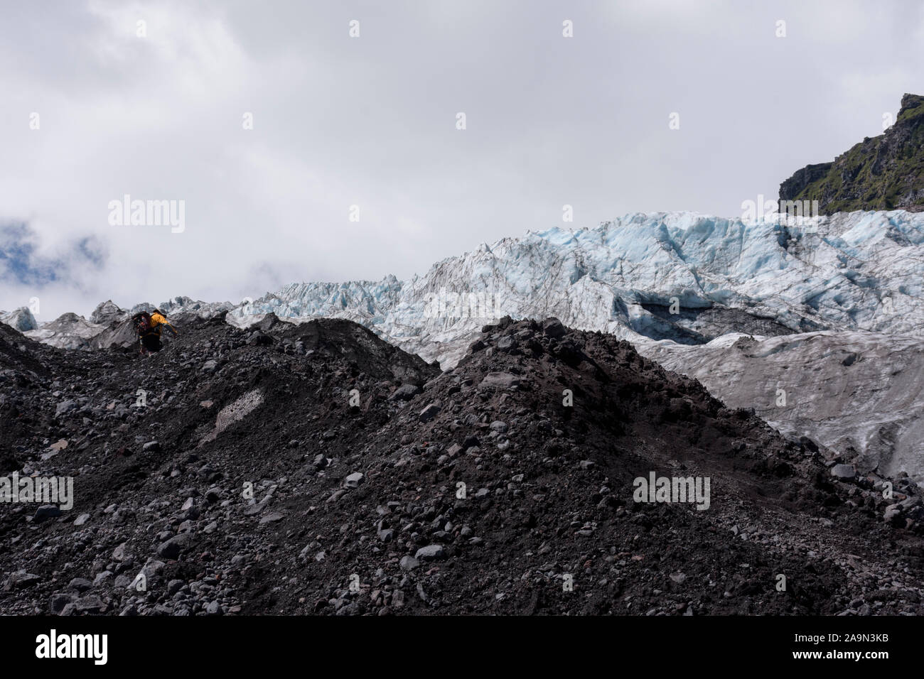 Rear view mountaineer reaching Michinmahuida glacier in Pumalin Park ...