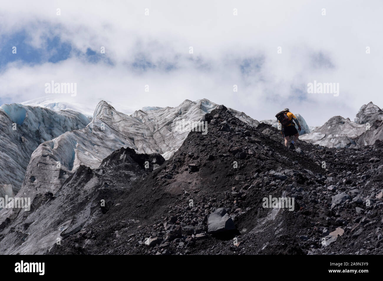 Rear view mountaineer reaching Michinmahuida glacier in Pumalin Park ...