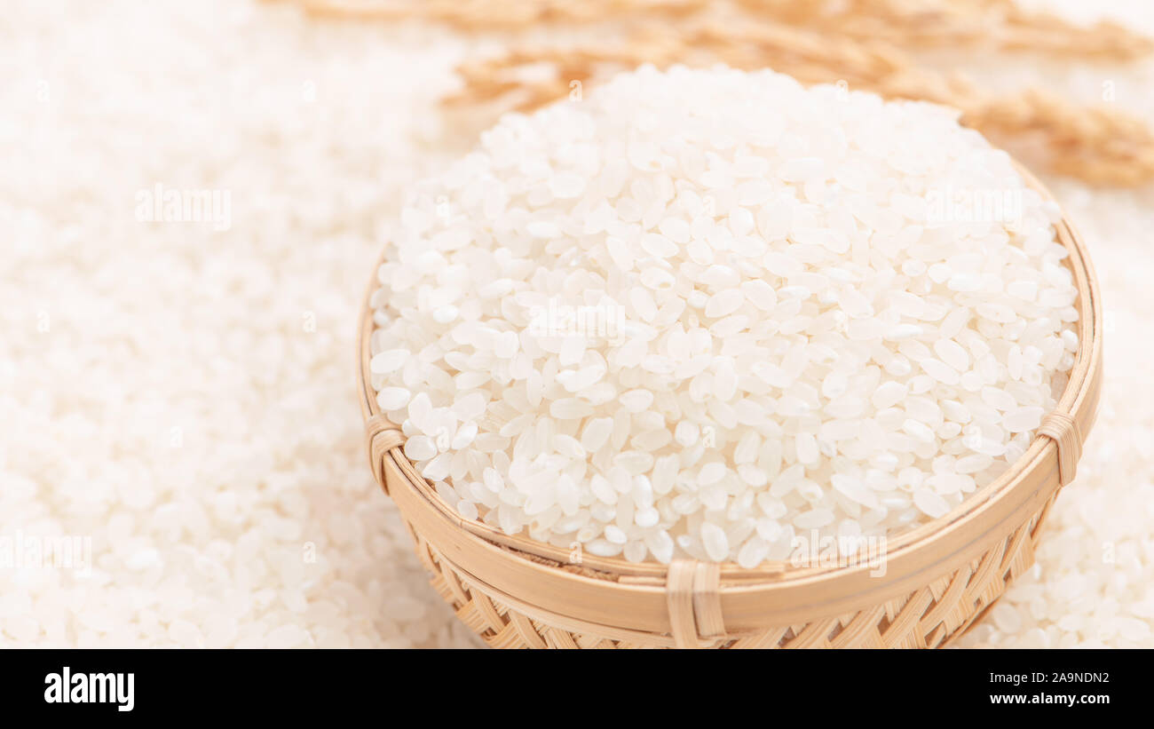 Raw white polished milled edible rice crop on white background in brown ...