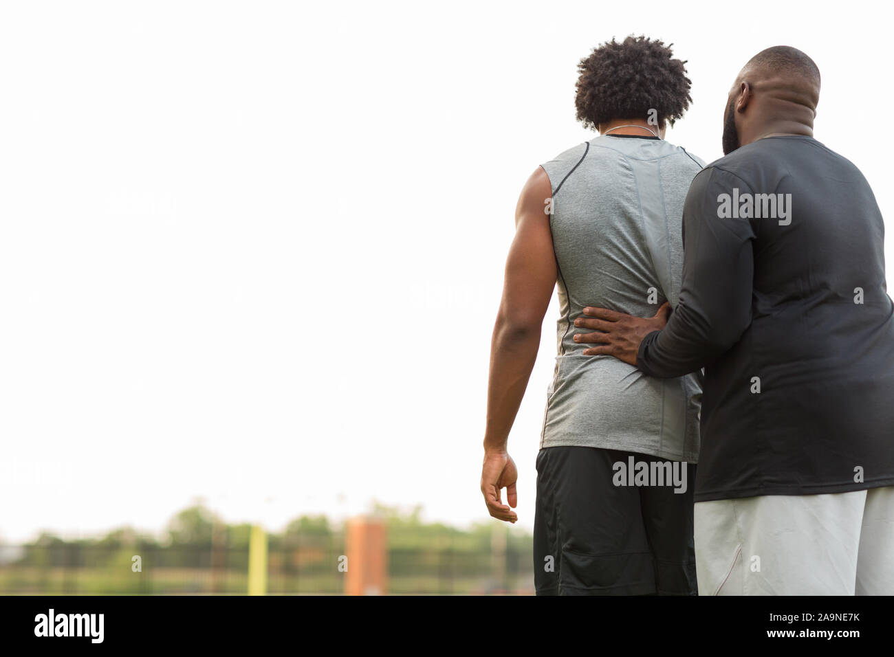 American Football coach training a young athlete Stock Photo - Alamy