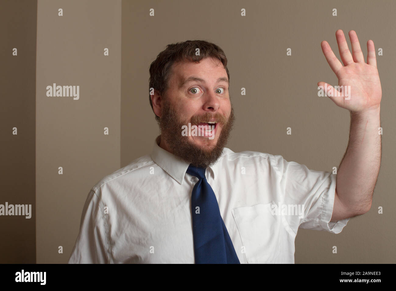 man waving hello at you with a big smile Stock Photo - Alamy