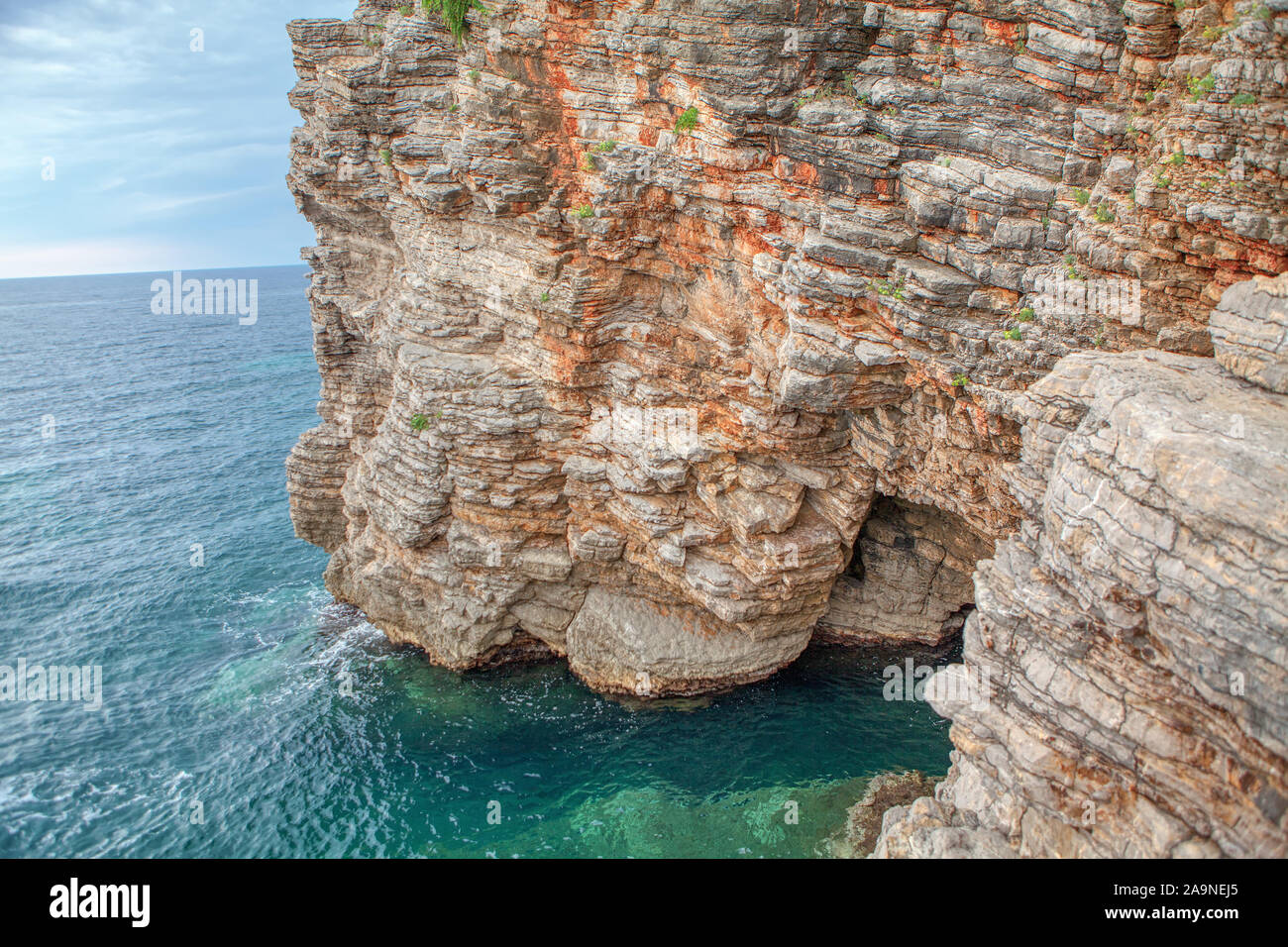 sea cave in the coastal cliff Stock Photo - Alamy