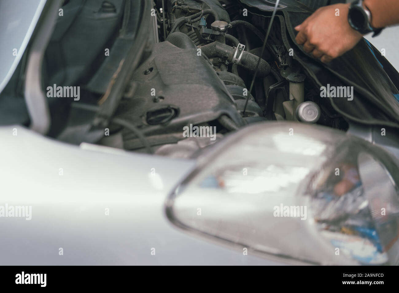 technician checking motor oil level for maintenance car engine in auto ...
