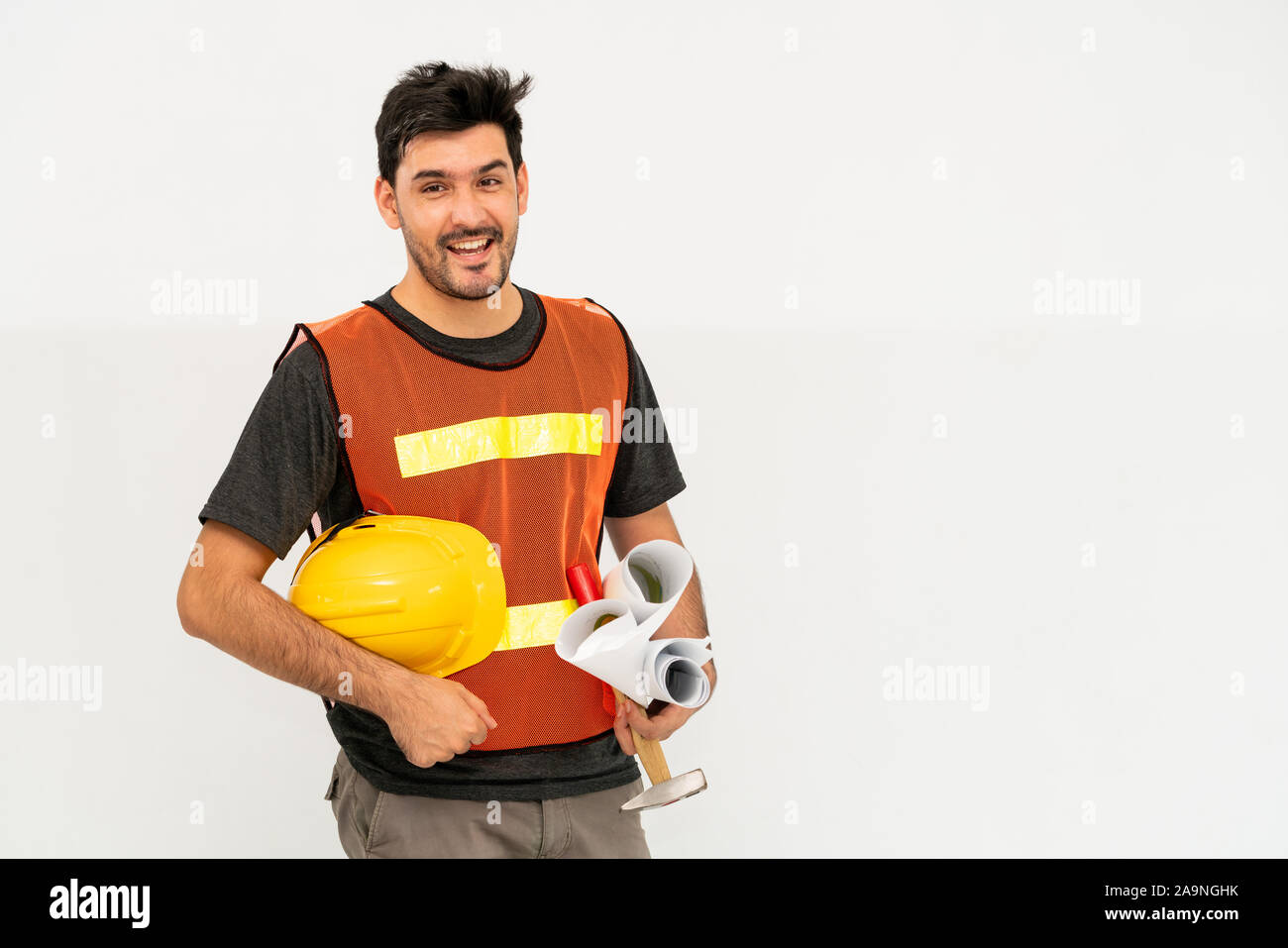Young male handsome construction worker standing on white background ...