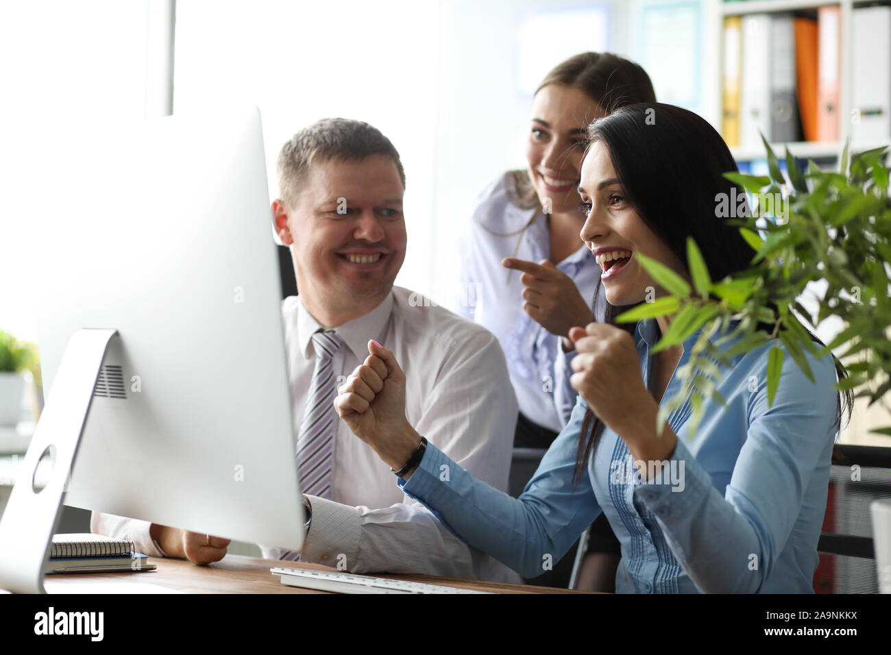 Group of people at office workplace watching show at computer display ...