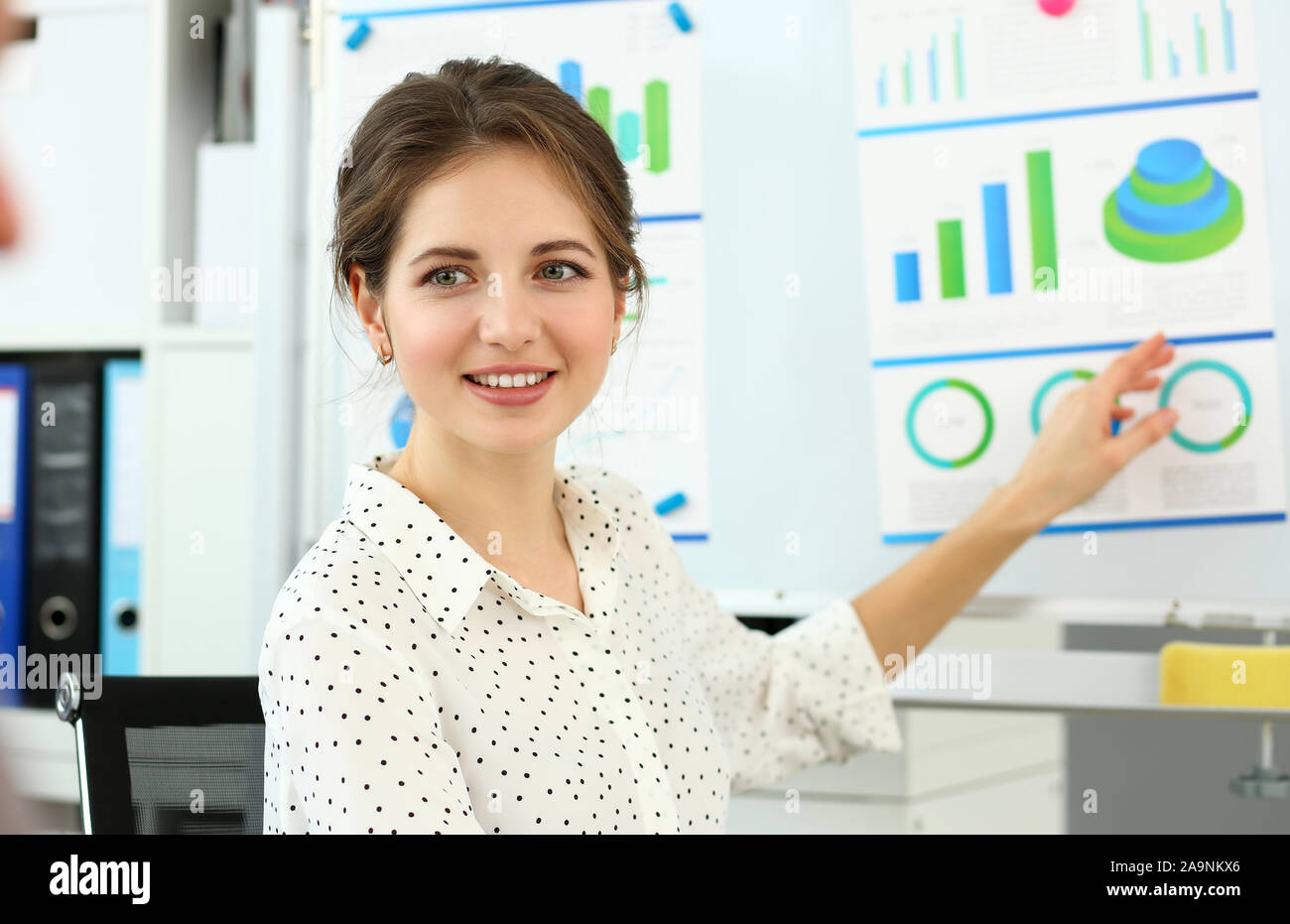 Smiling beautiful woman in office telling something important Stock ...