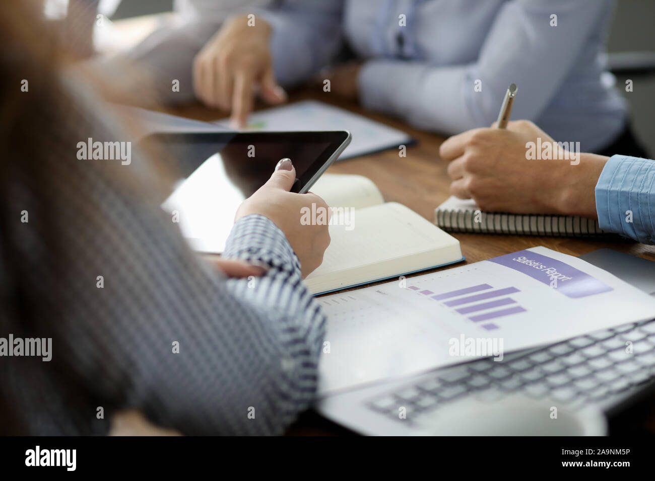 Workteam writing report Stock Photo - Alamy